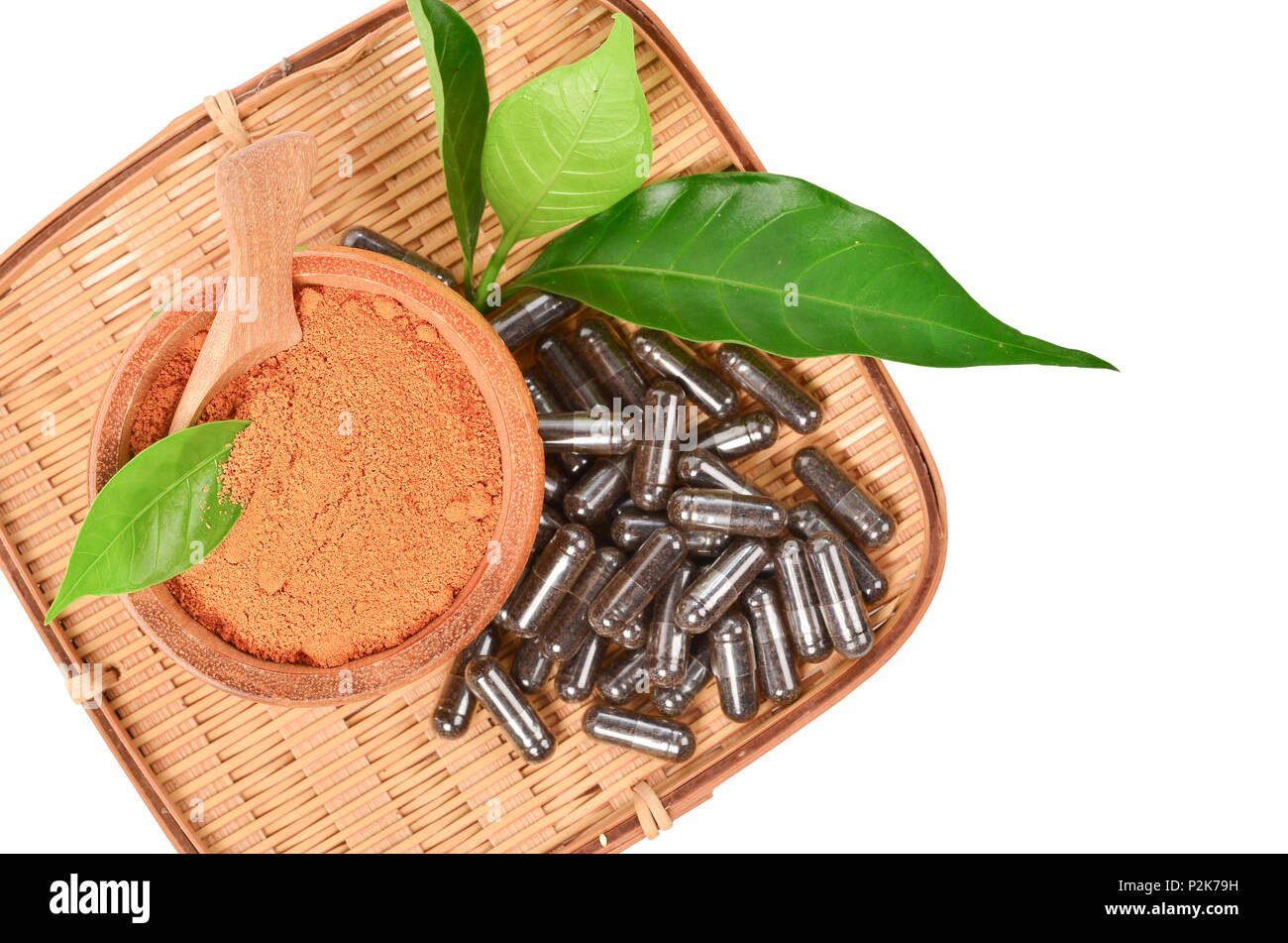 Natural medicine capsule pill with black herb, and wooden mortar on ...