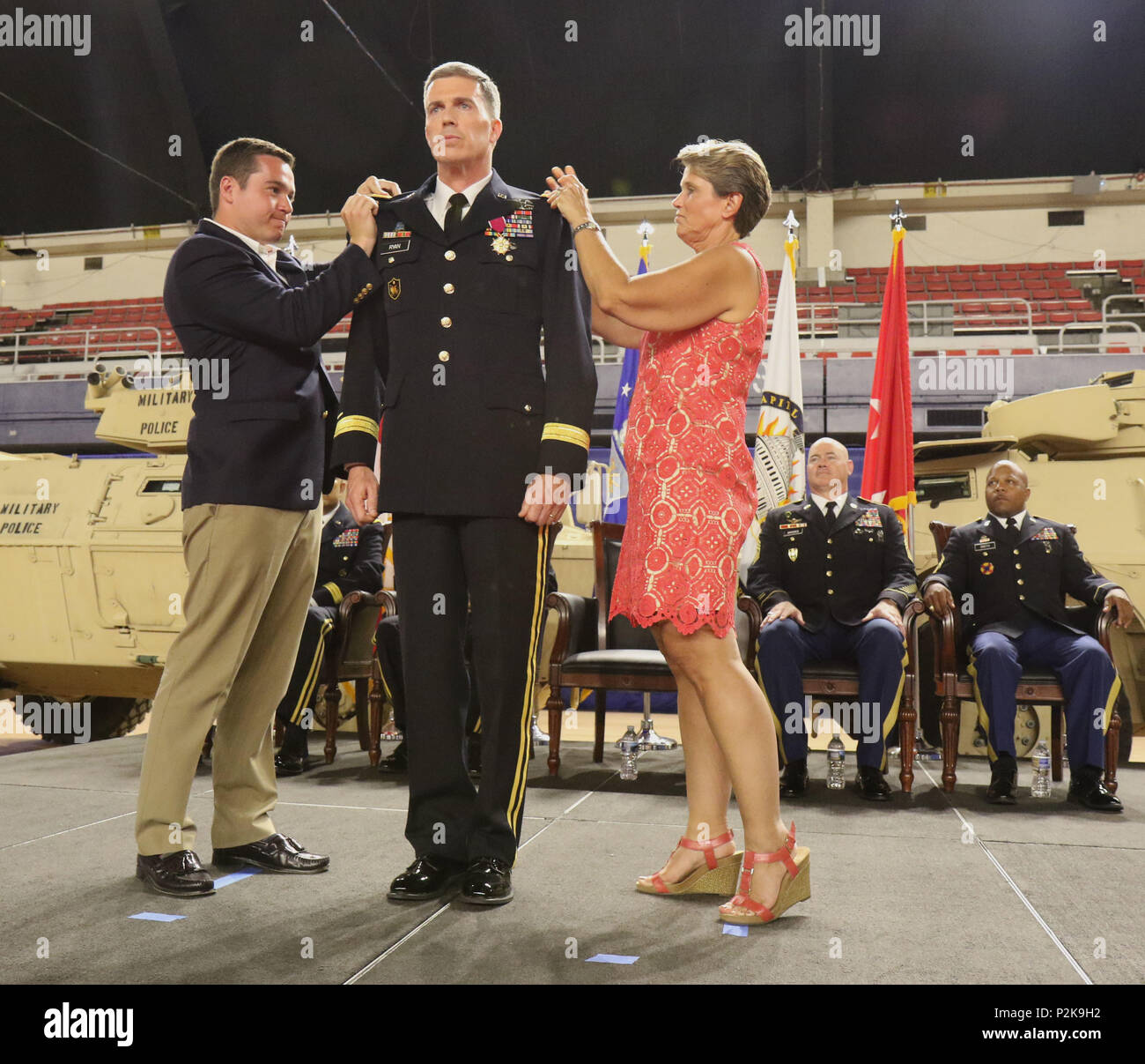 WASHINGTON- Members of Col. Robert K. Ryan's family pin on his new rank ...