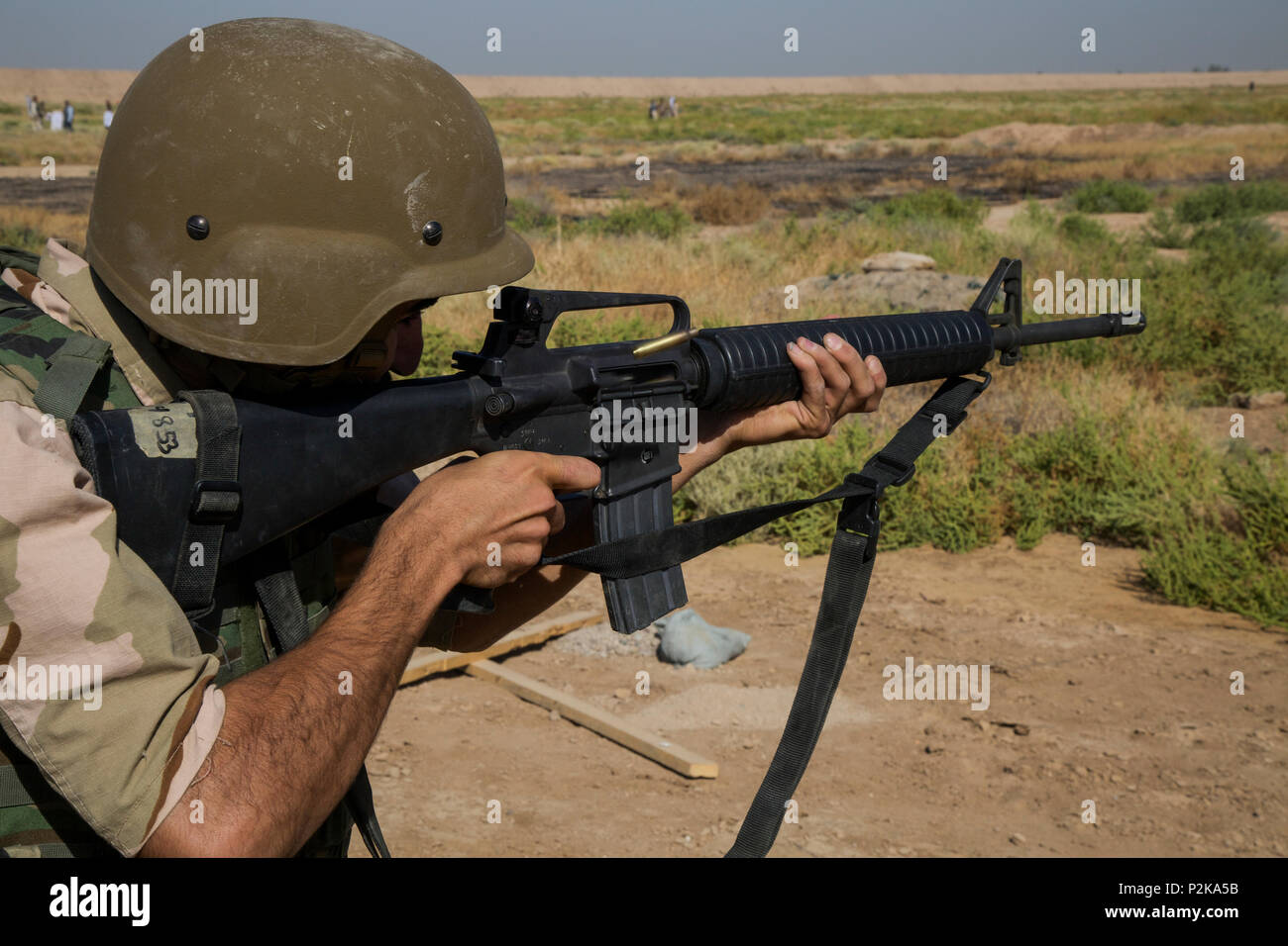 An Iraqi soldier assigned to the 75th Iraqi Army Brigade fires his M16 ...