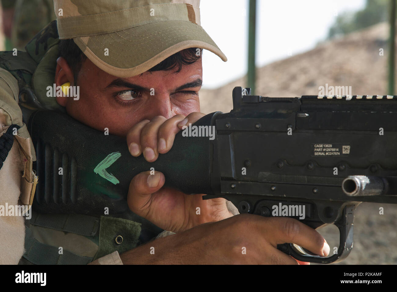An Iraqi soldier of the 76th Iraqi Army brigade, fires his M240B ...