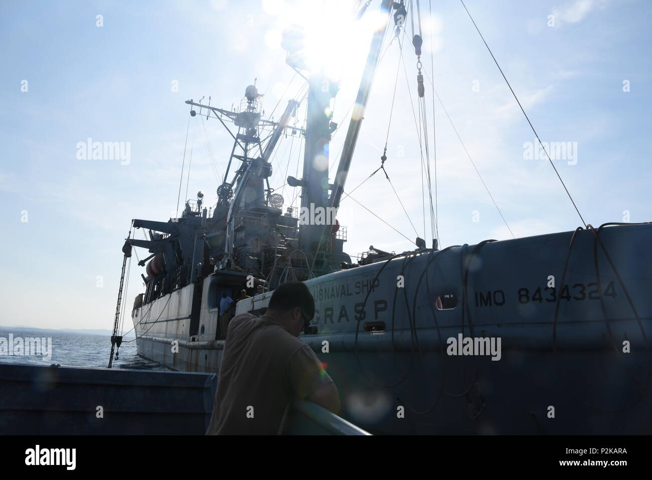 U.S. Naval Ship Grasp (T-ARS-51) anchors down to conduct an underwater ...