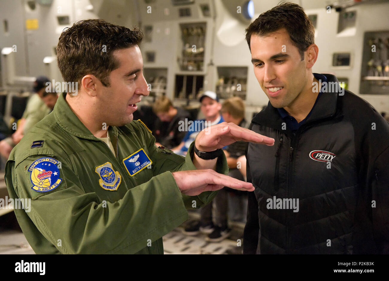 Capt. Matt Plourde, 3d Airlift Squadron pilot, left, explains to Aric ...