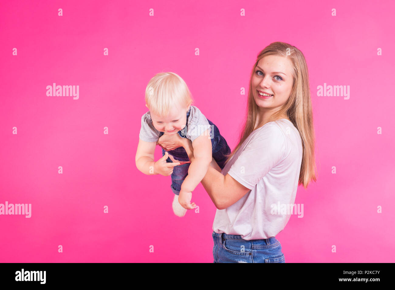 Funny family on pink background. Mother and her daughter girl. Mom and ...