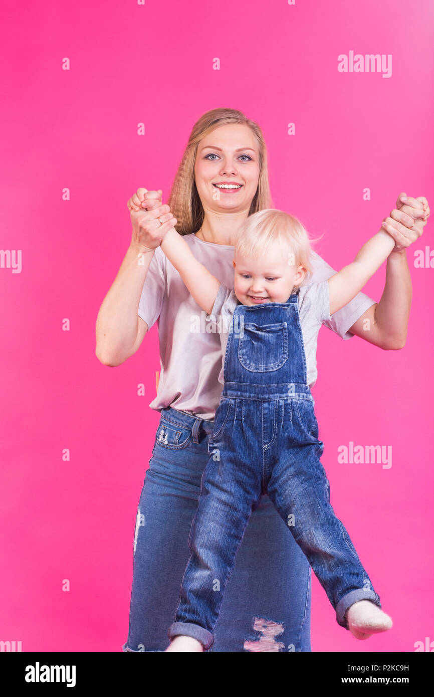 Funny family on pink background. Mother and her daughter girl. Mom and ...