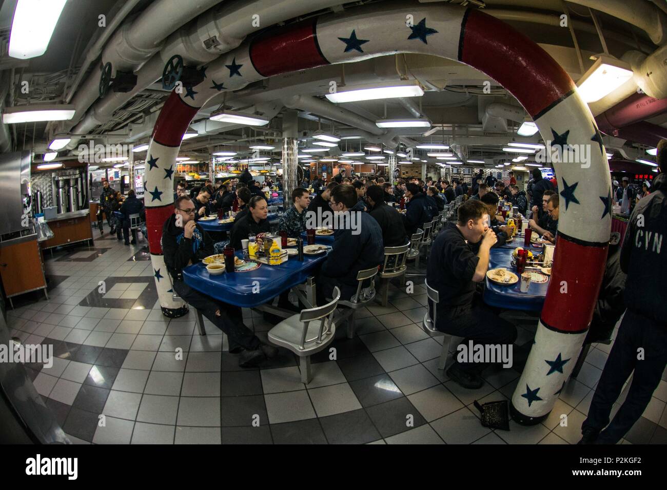 Sailors enjoy a Thanksgiving meal with shipmates and family members on ...