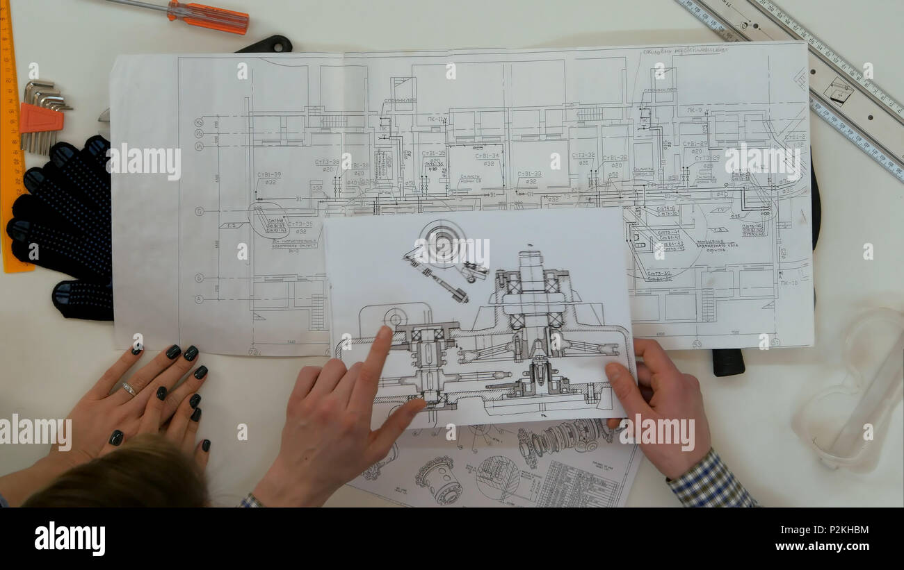 Young architects working on blueprints Stock Photo - Alamy