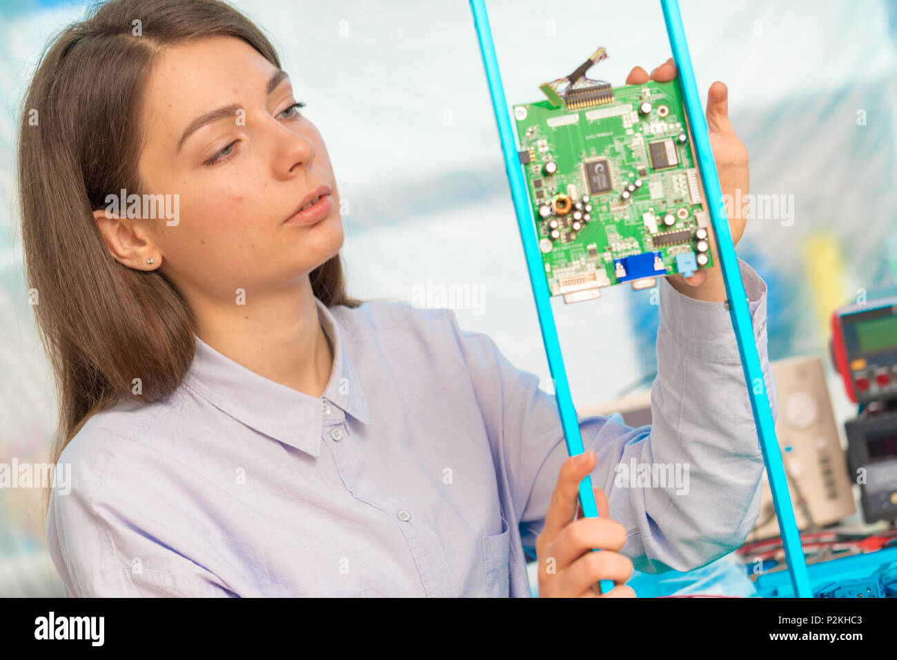 Female student in electronics class uses a Measuring device Stock Photo ...
