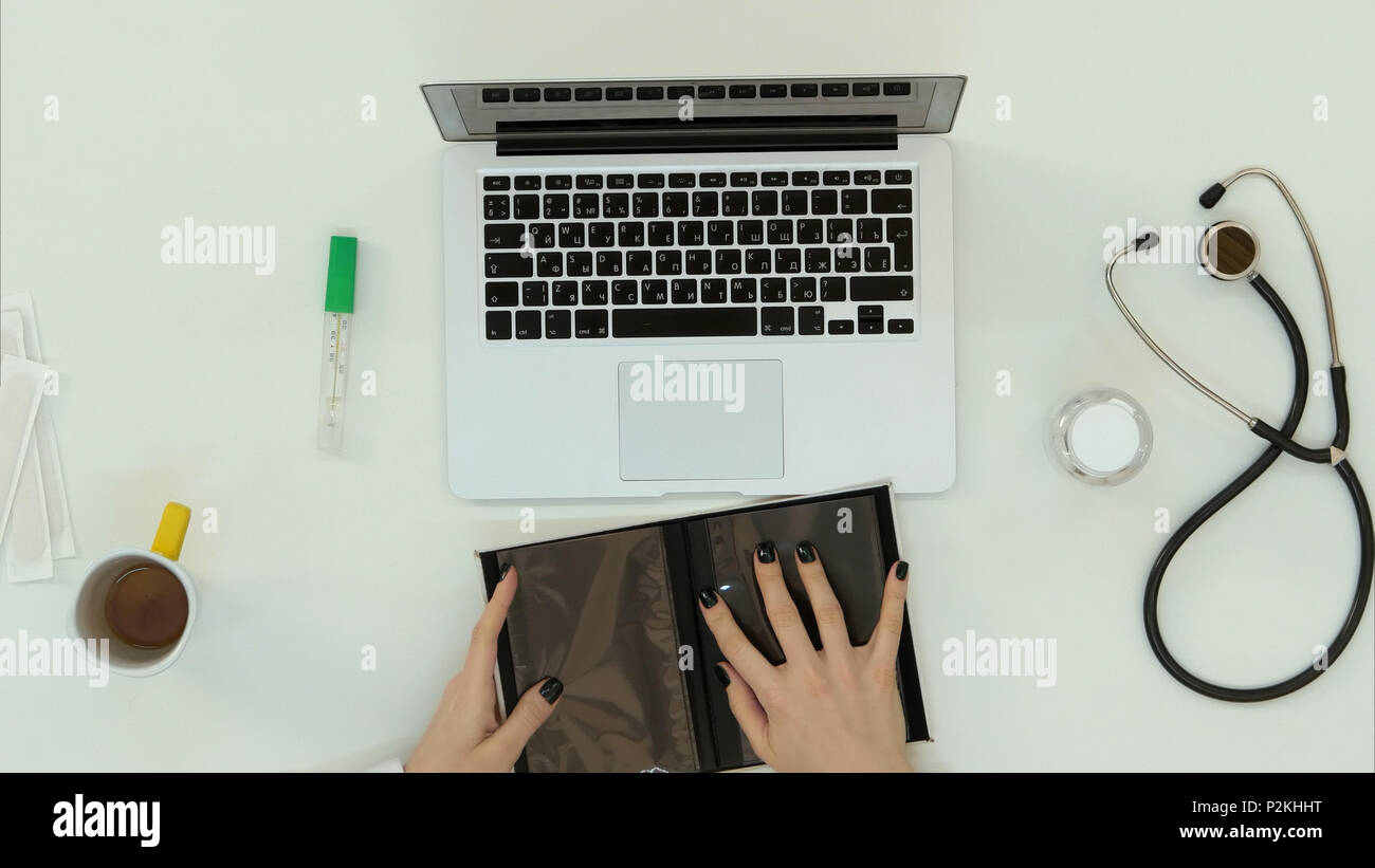 Female doctor hands arranging things at work desk Stock Photo - Alamy