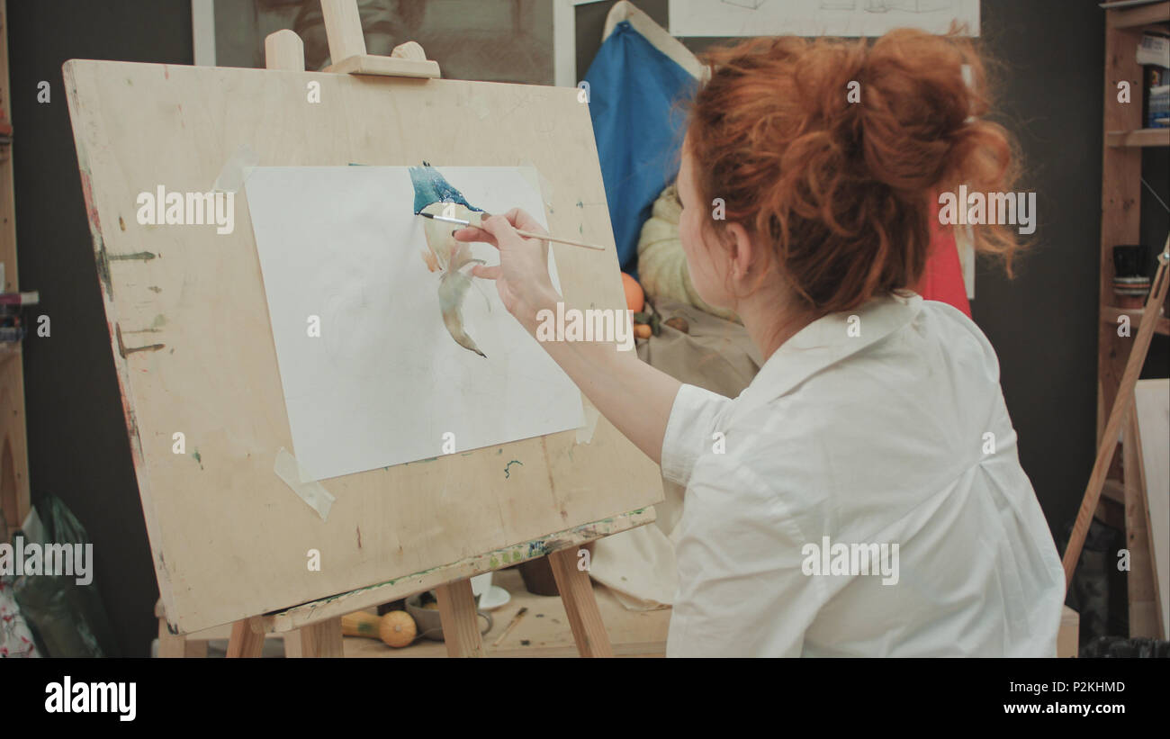 Young female artist painting still life in studio Stock Photo - Alamy