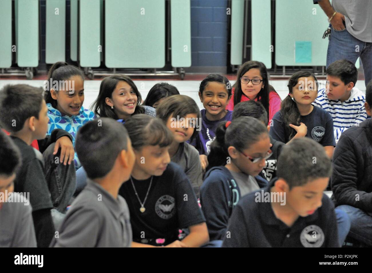 April Ruiz, purple shirt, and her classmates smile for the camera while ...