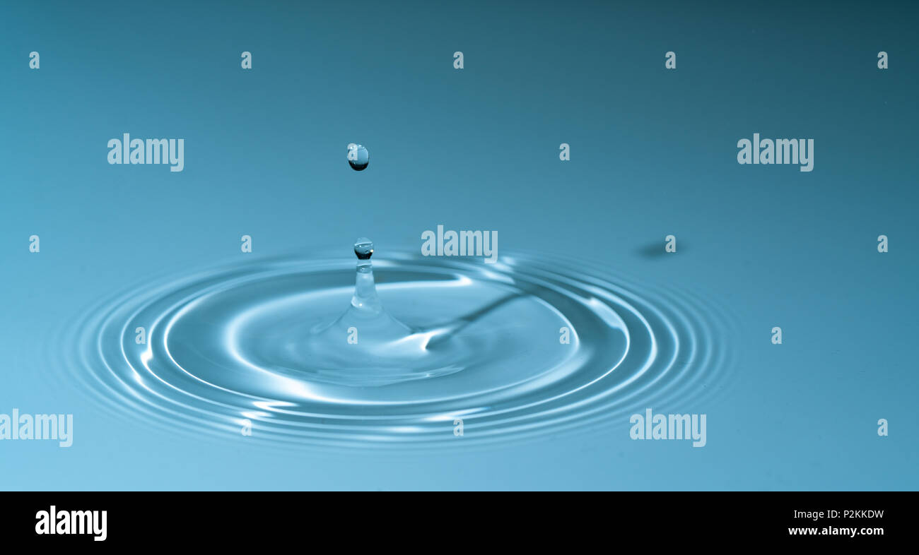 Falling water drop splash Stock Photo - Alamy