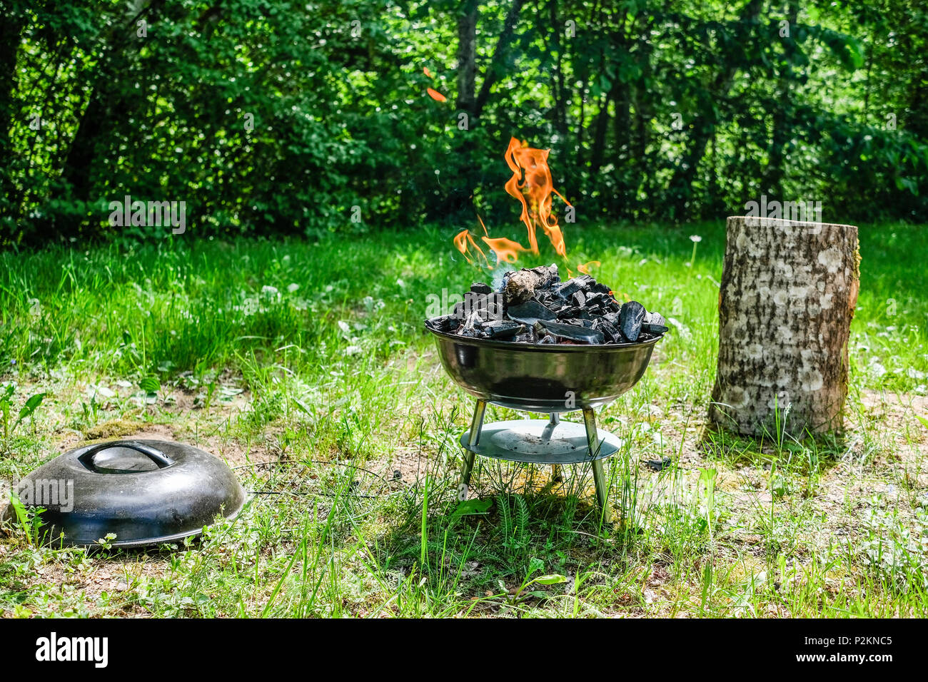 Fire on barbecue charcoal grill. Grilling food on a weber type small ...