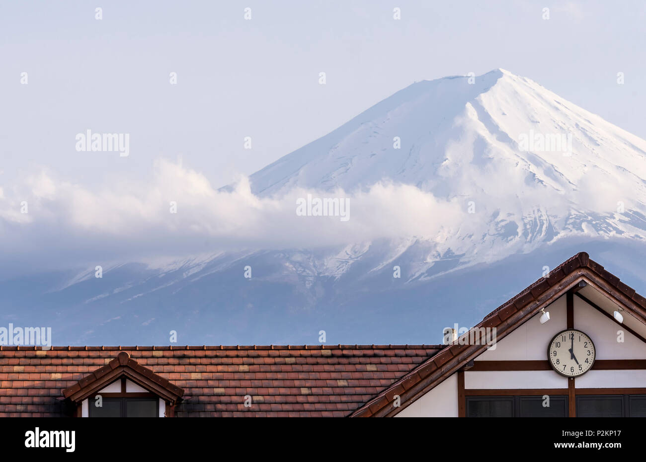 Clock that marks five o'clock with the snowy peak of Mount Fuji, Japan ...