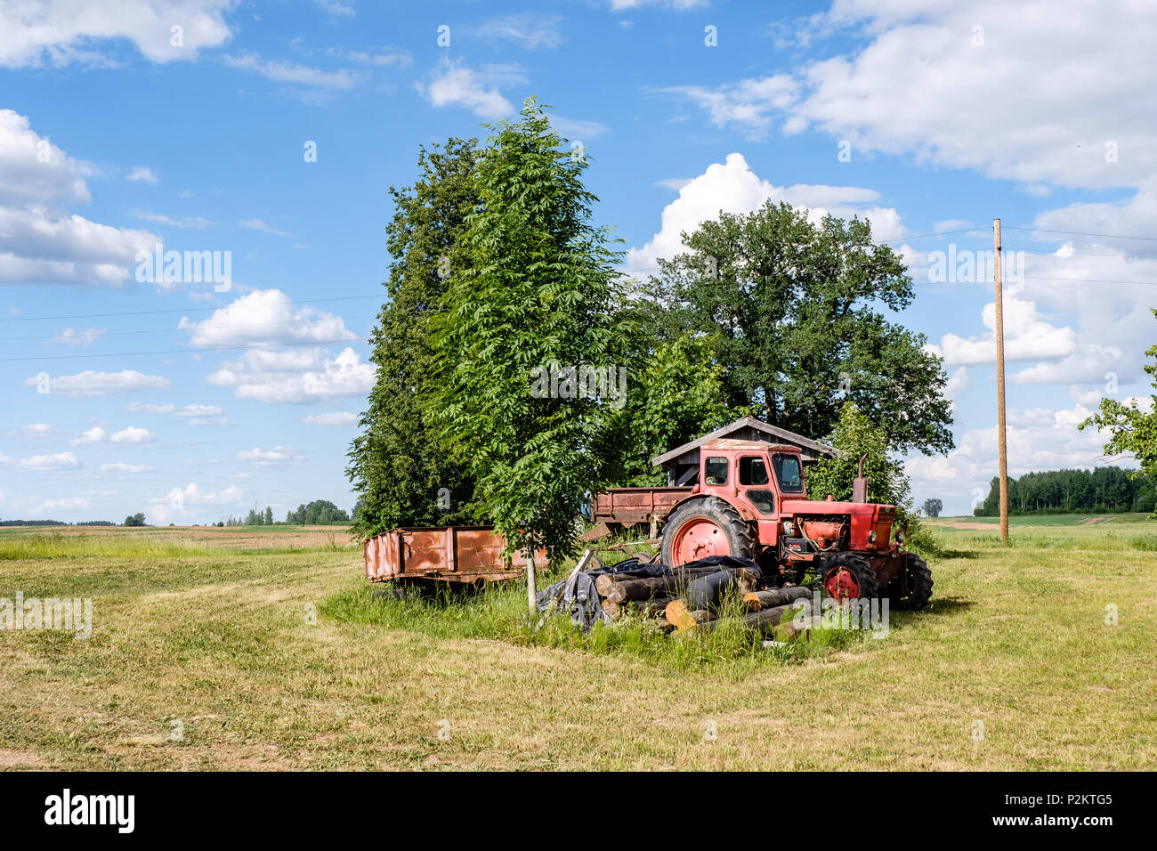 Detail of red tractor in countryside. engine parts and tires Stock ...