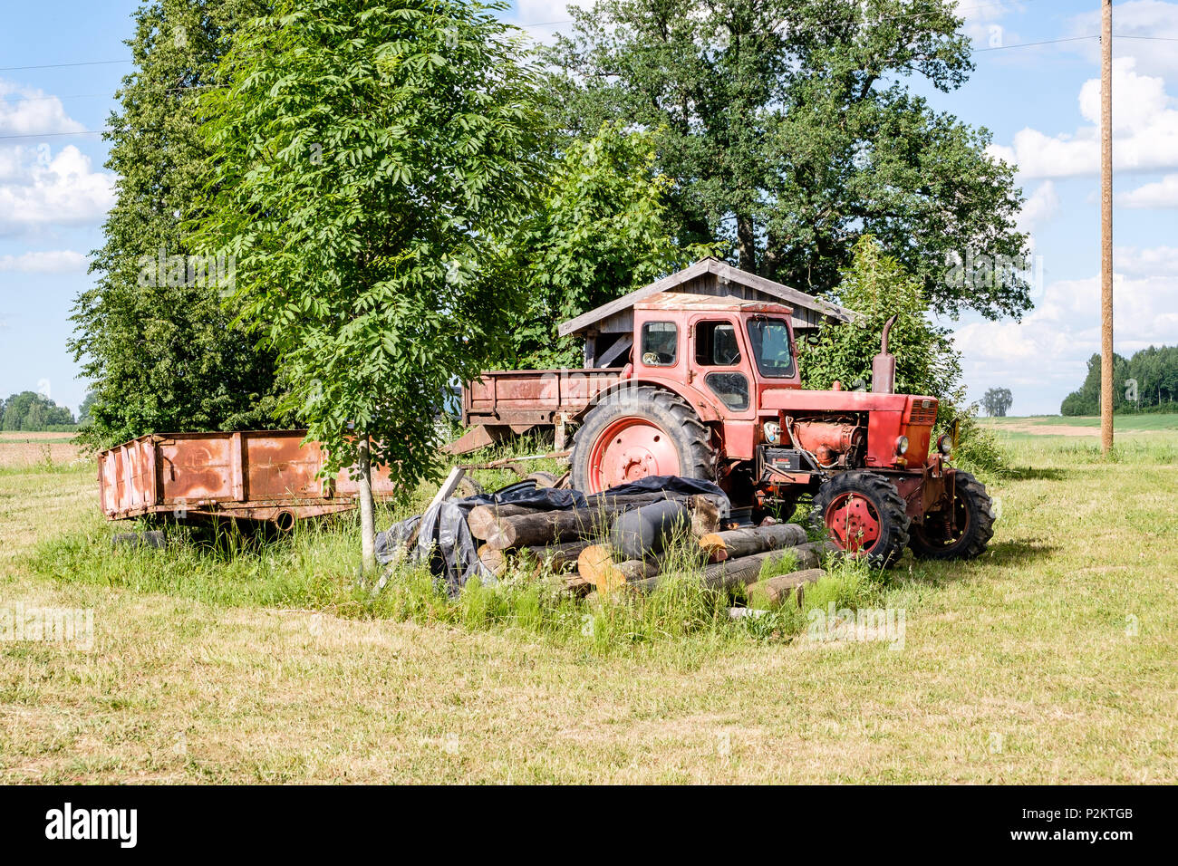 Detail of red tractor in countryside. engine parts and tires Stock ...