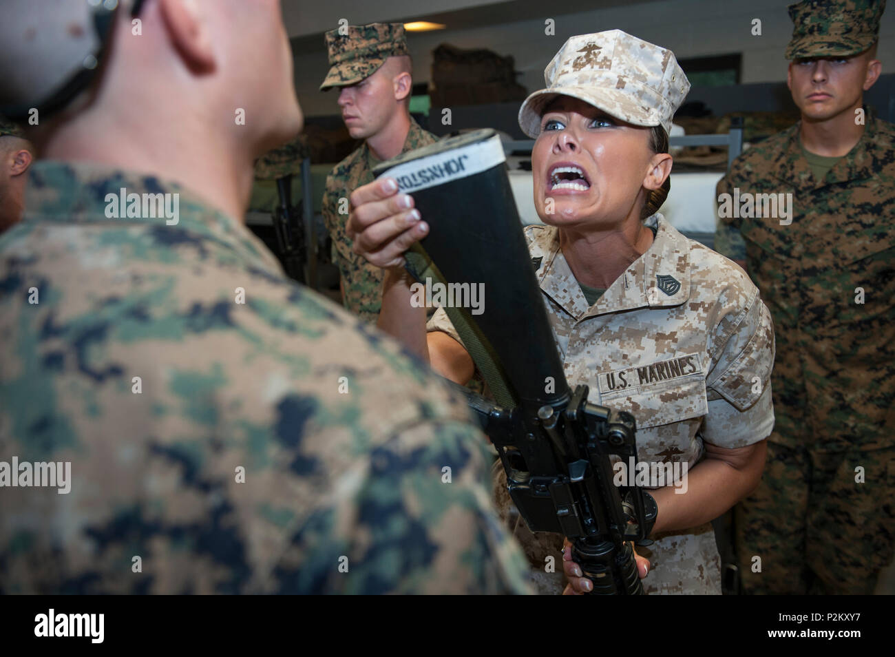 U.S. Marine Drill Instructor Gunnery Sgt. Leigh Bibona corrects a candidate during Charlie ...