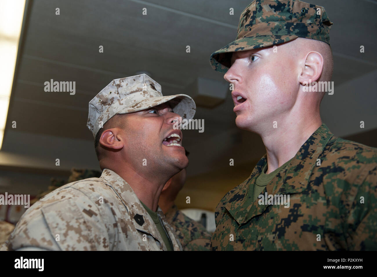 U.S. Marine Drill Instructor Gunnery Sgt. Rodney Sanchez corrects a ...