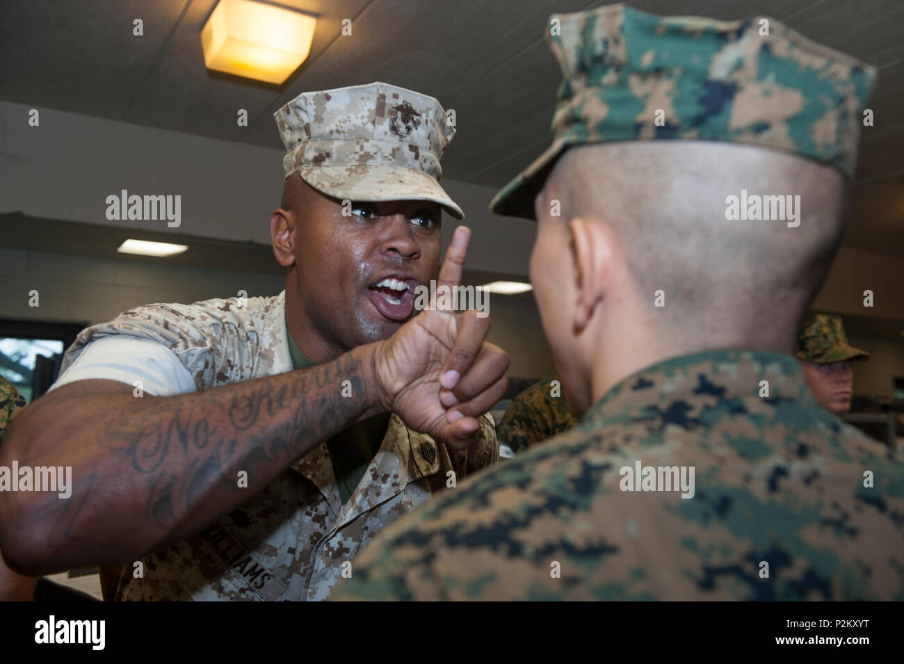 U.S. Marine Drill Instructor Gunnery Sgt. James Williams corrects a candidate during Charlie ...