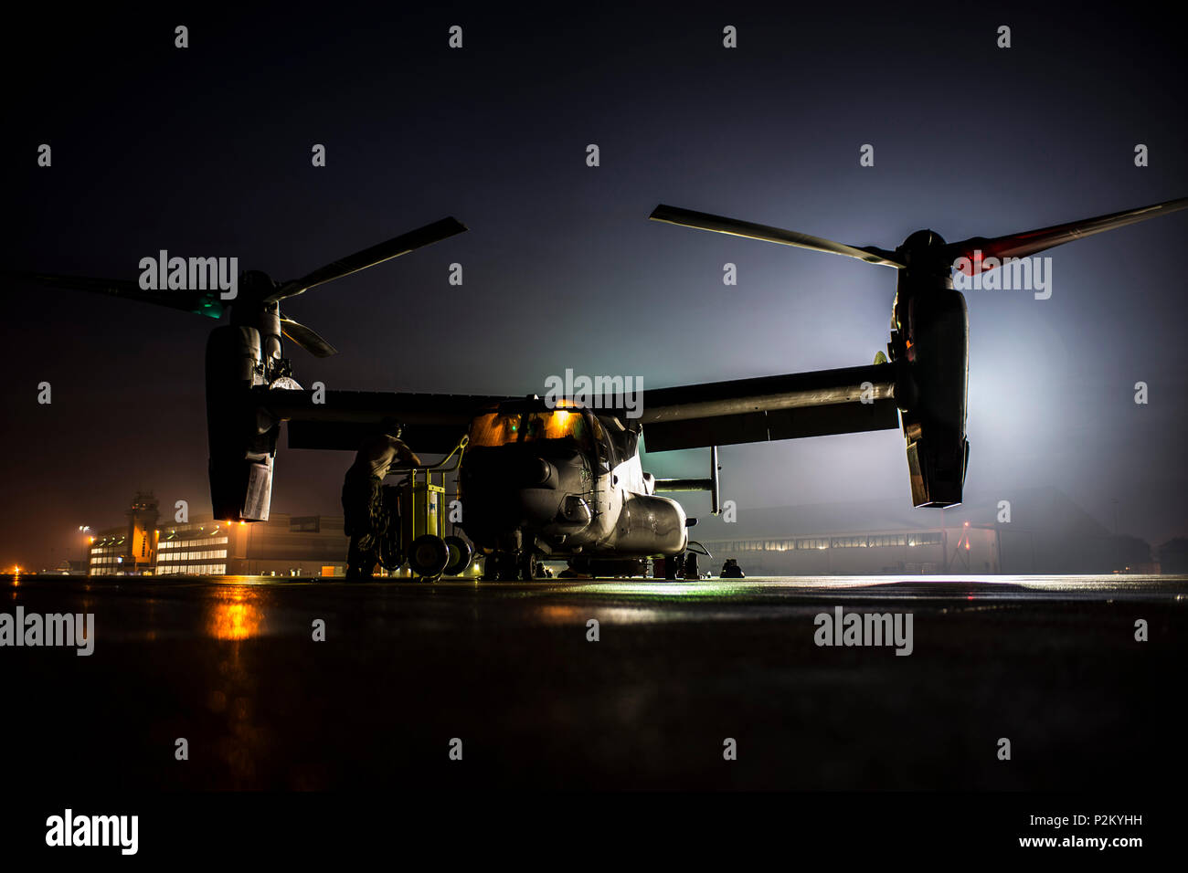 A 20th Special Operations Squadron Airman looks over the front of a CV ...