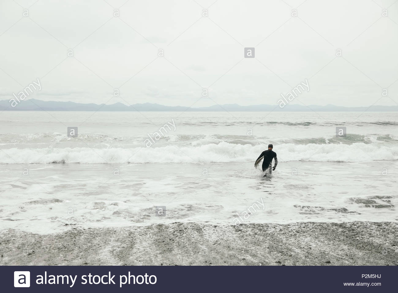 Man wading into ocean hi-res stock photography and images - Alamy