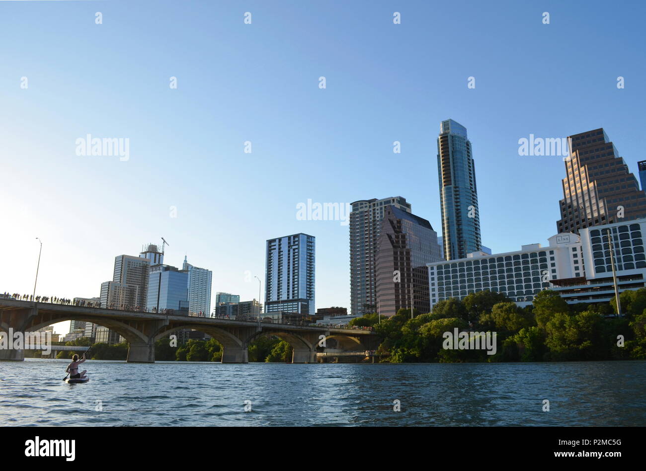A woman sits on a paddle board while floating on Ladybird Lake as a ...