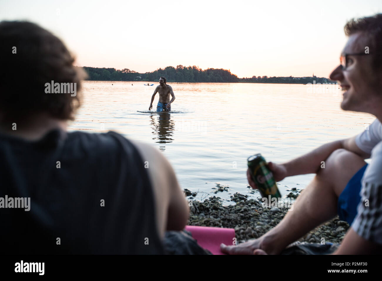 Three young men camping at a lake, Freilassing, Bavaria, Germany Stock ...