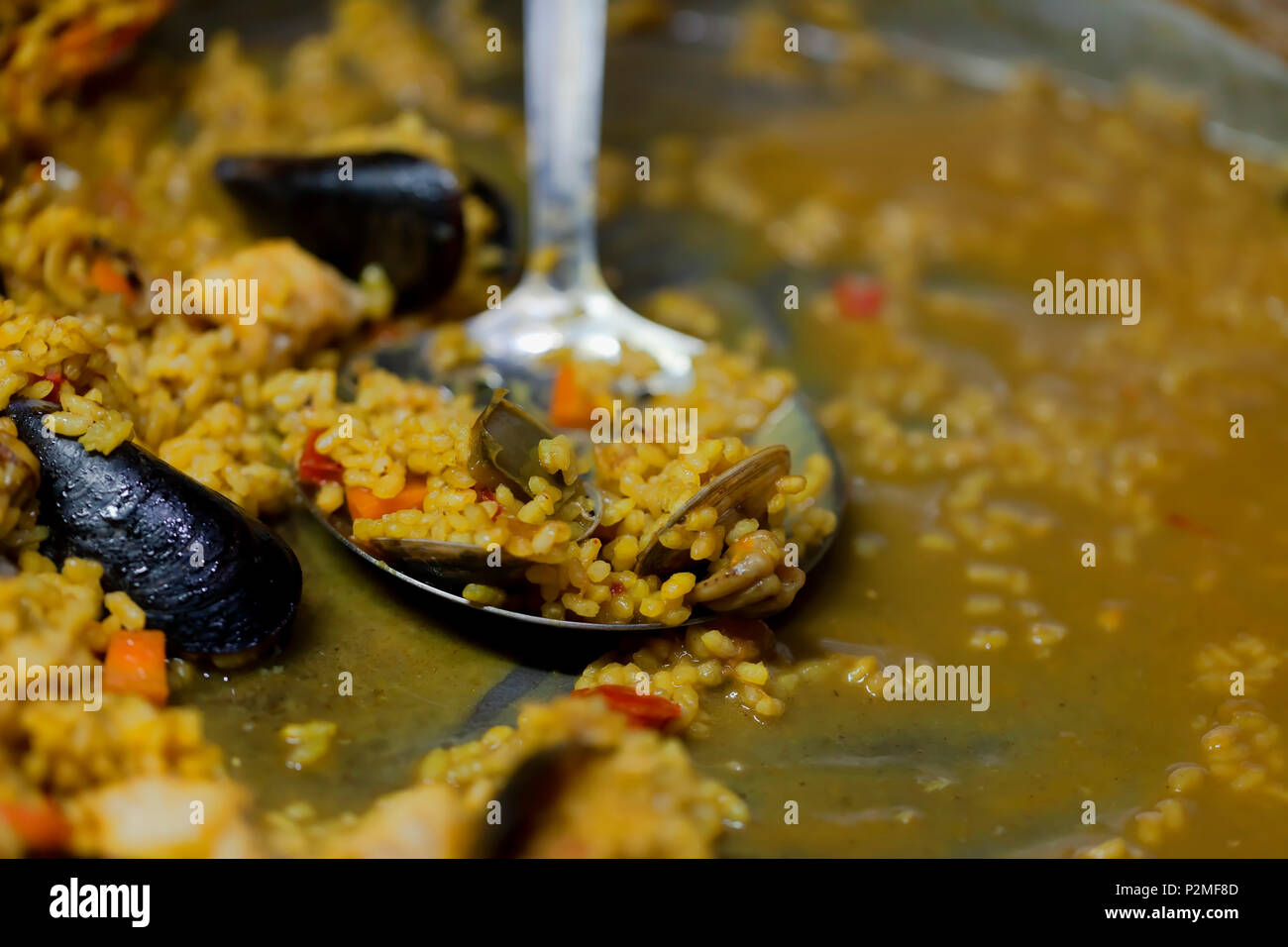 Last portions of a typical spanish fish paella Stock Photo - Alamy
