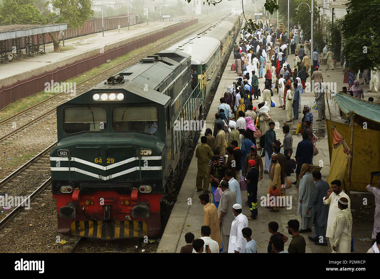 Lahore, Pakistan. 14th June, 2018. People ride on a crowded passenger ...