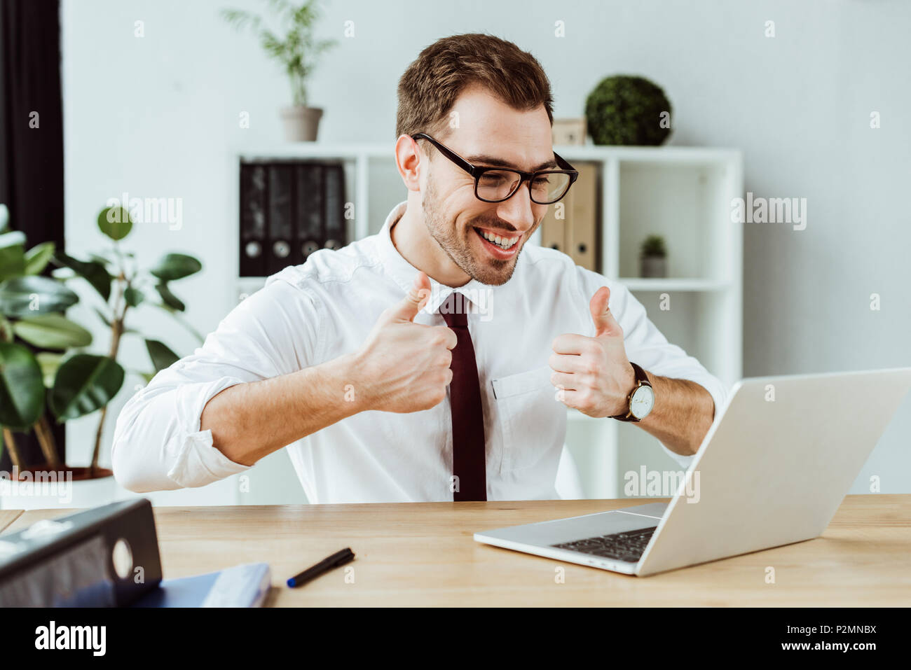 Businessman making thumbs up working hi-res stock photography and ...