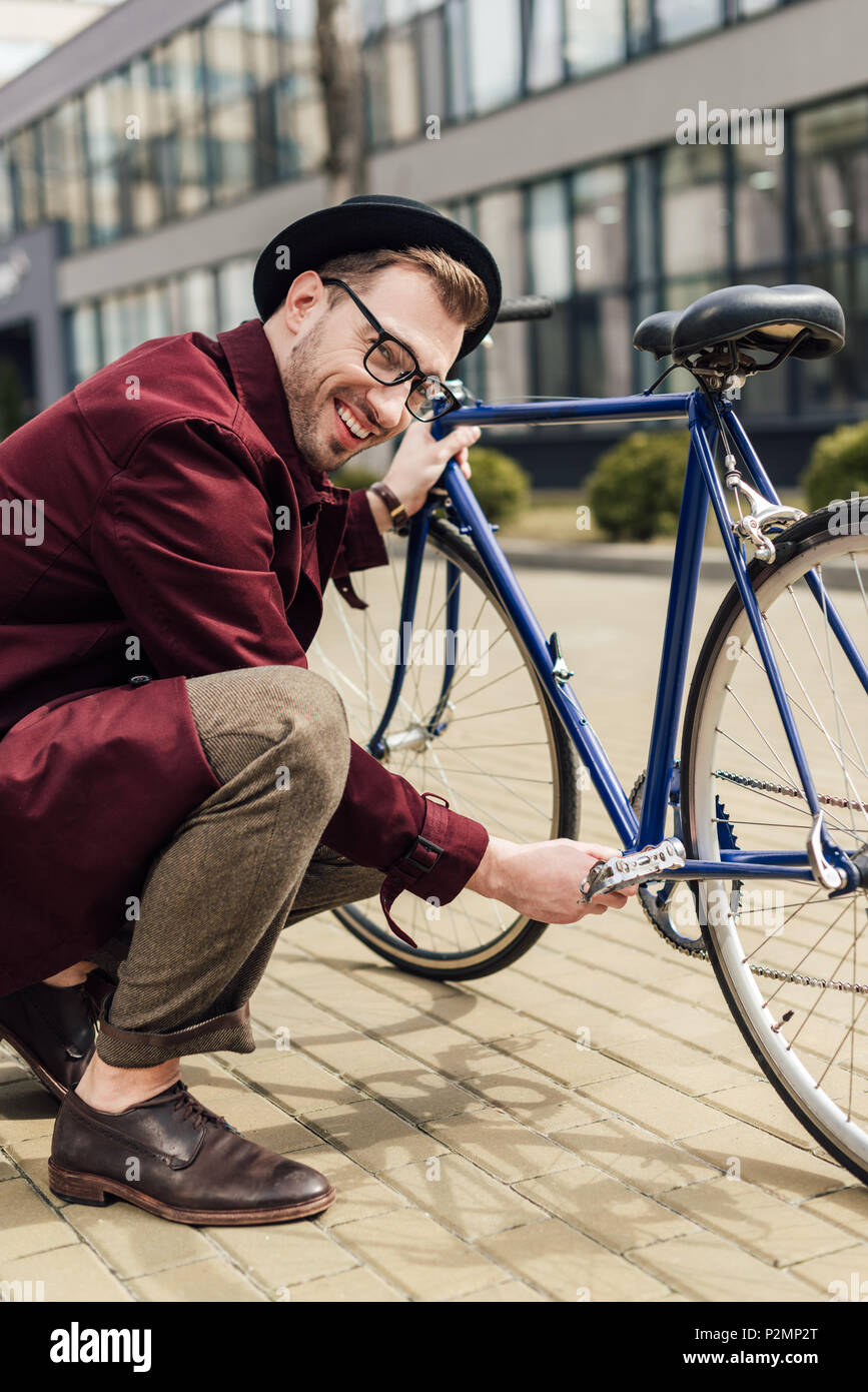 Man fixing bike hi-res stock photography and images - Alamy