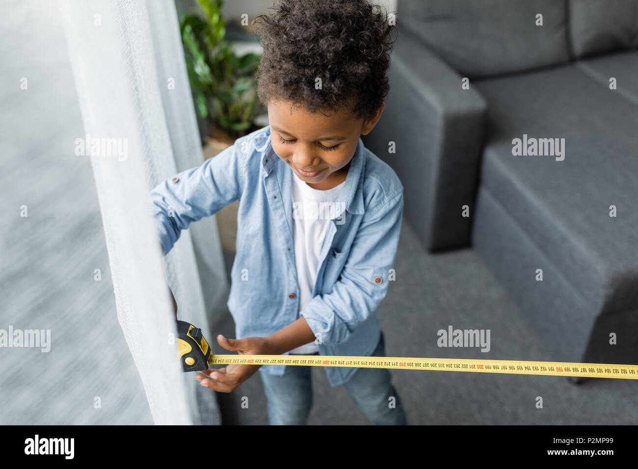 adorable happy african-american boy with measuring tape Stock Photo - Alamy