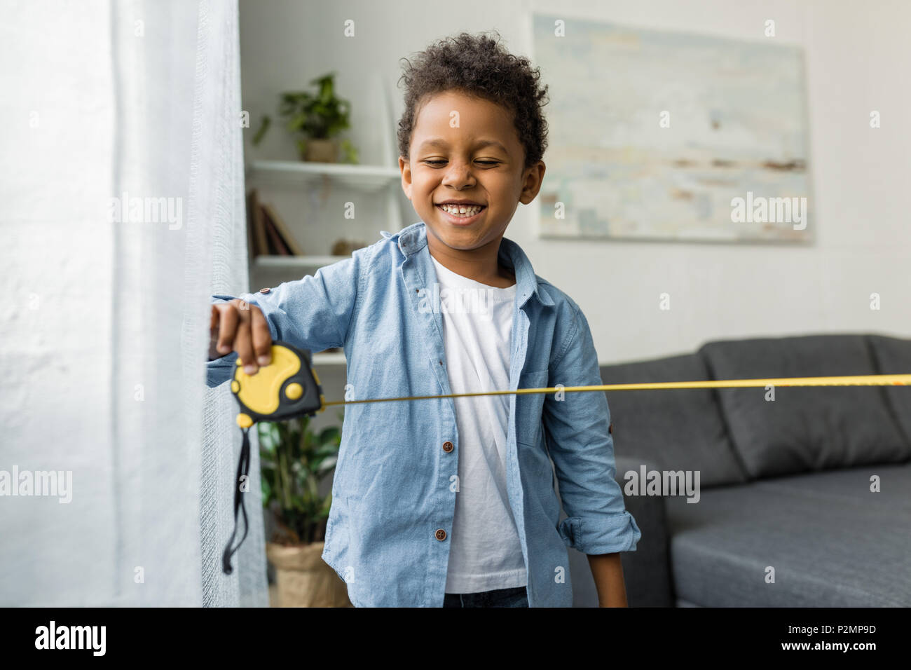 adorable smiling african-american boy with measuring tape Stock Photo ...