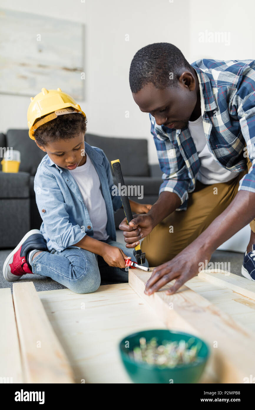 adorable african-american father and son constructing table Stock Photo ...