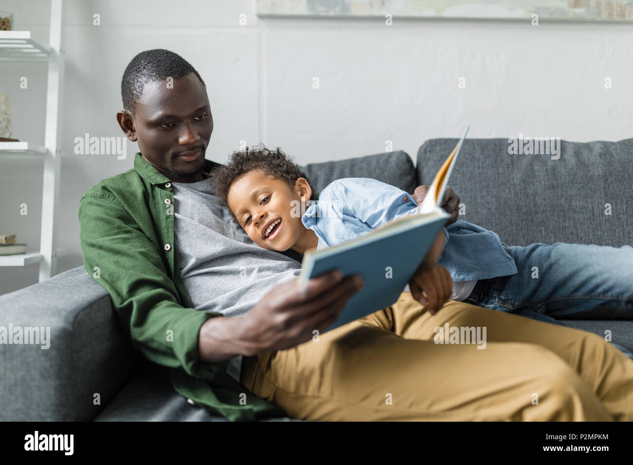 happy african-american father and son reading book together Stock Photo ...