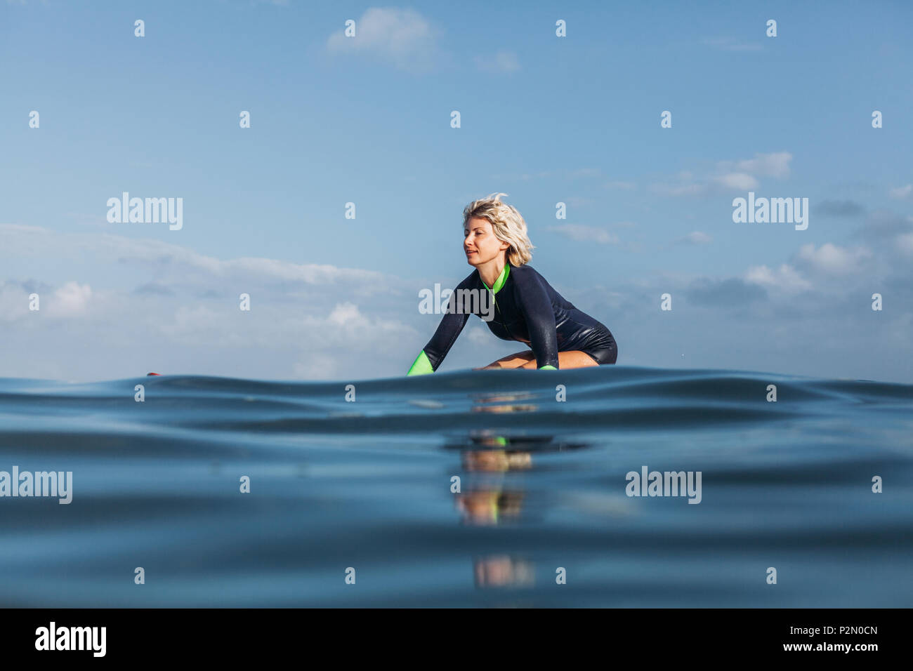 Girl sitting on surf board hi-res stock photography and images - Alamy