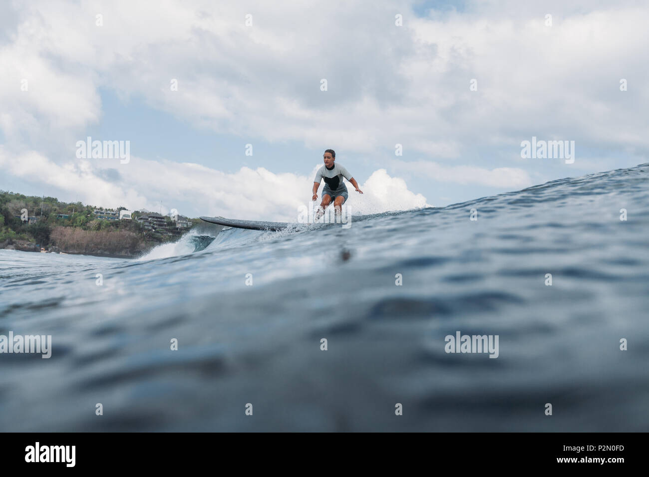 Woman riding wave hi-res stock photography and images - Alamy