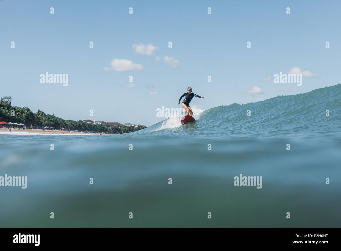 female surfer riding wave on board in ocean Stock Photo - Alamy