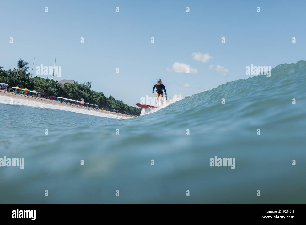 Female surfer riding ocean wave Stock Photo - Alamy