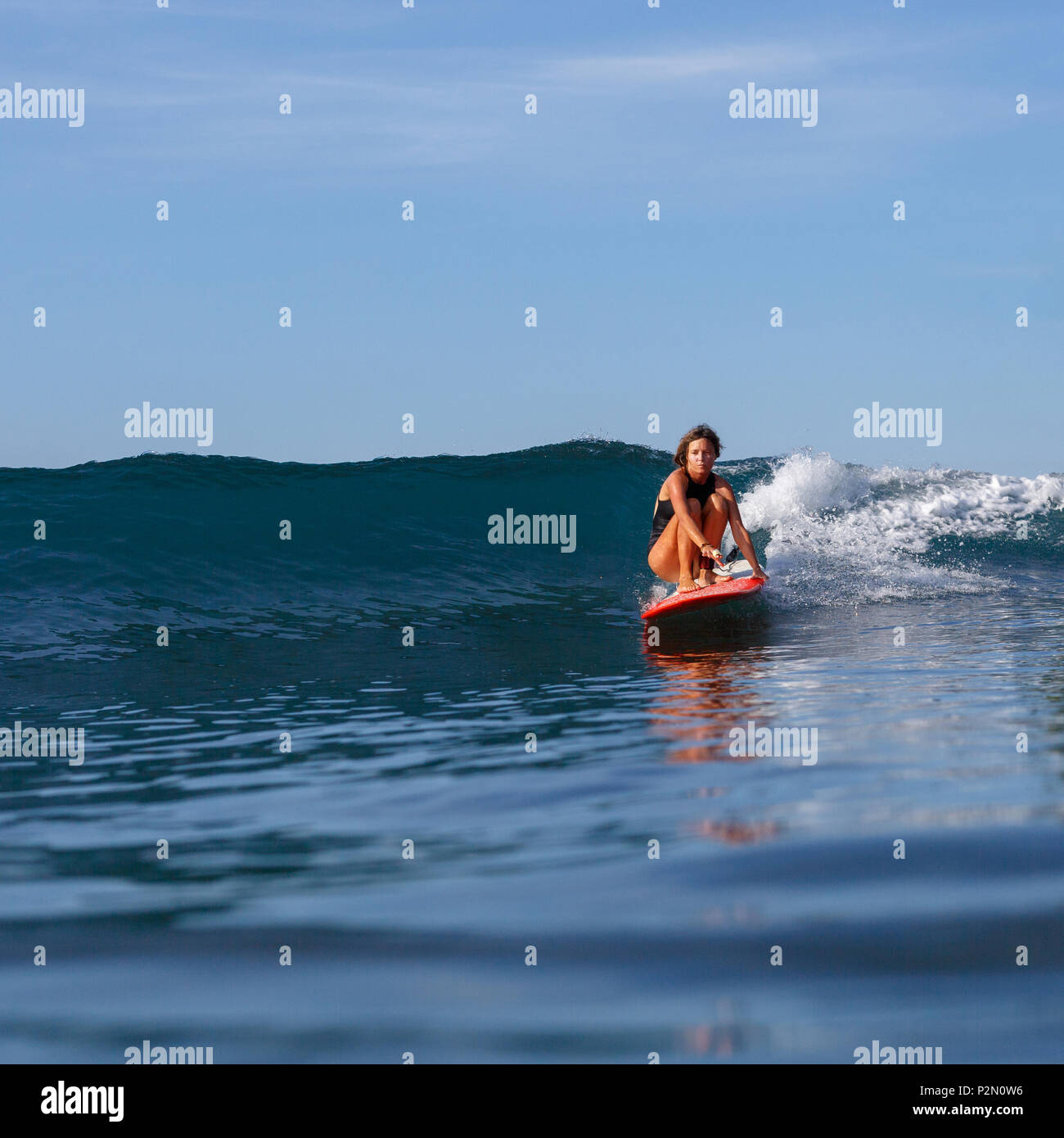 Young girl surfer riding wave hi-res stock photography and images - Alamy