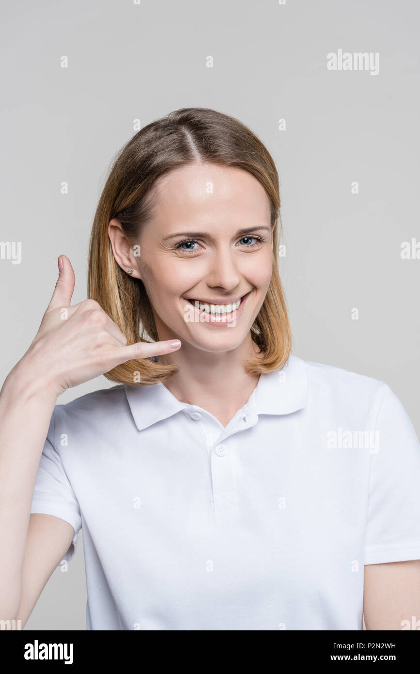 portrait of attractive cheerful woman with call me symbol, isolated on ...