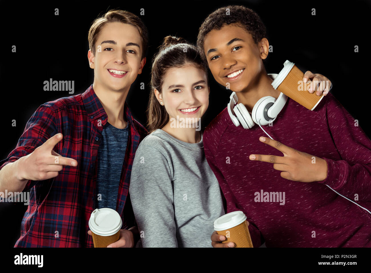 group of teenagers with paper cups of coffee isolated on black Stock ...