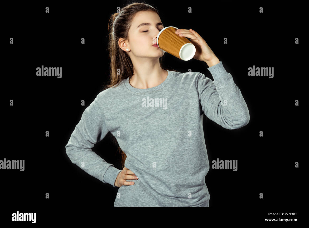 teen girl drinking coffee to go isolated on black Stock Photo - Alamy