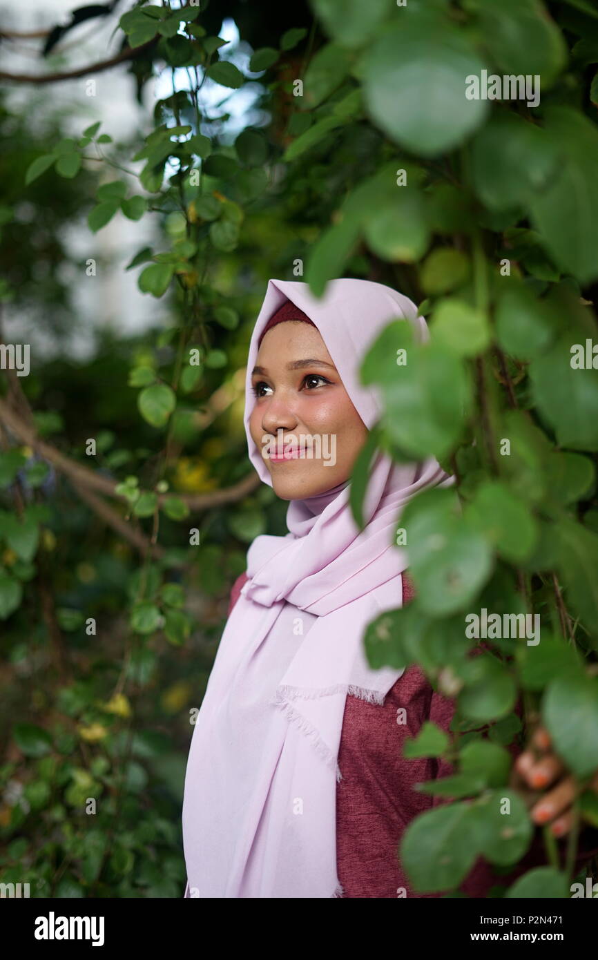 Young Muslim woman in Nature with beautiful smile Stock Photo - Alamy