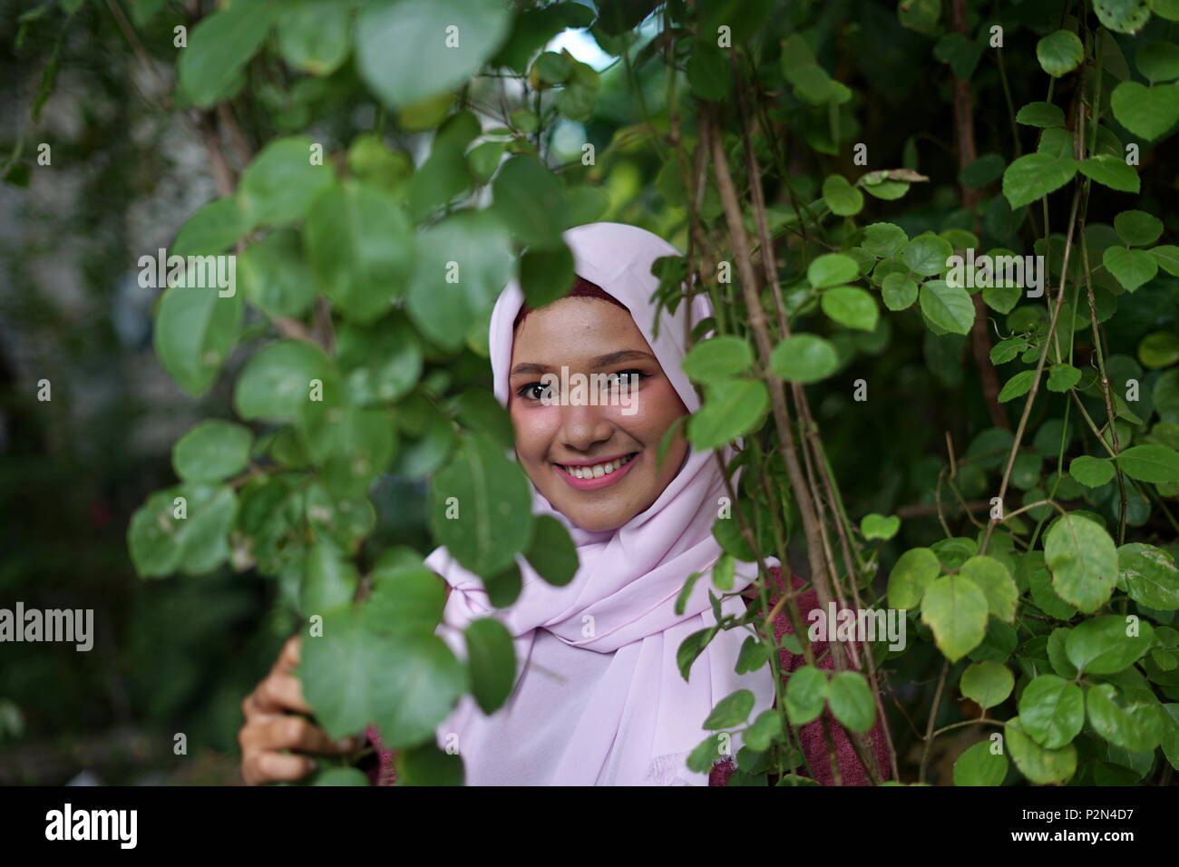Young Muslim woman in Nature with beautiful smile Stock Photo - Alamy