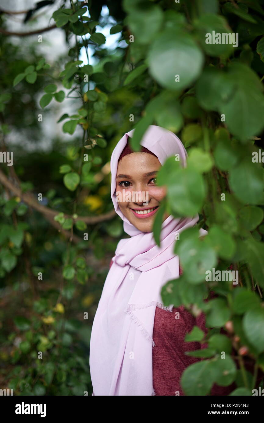 Young Muslim woman in Nature with beautiful smile Stock Photo - Alamy