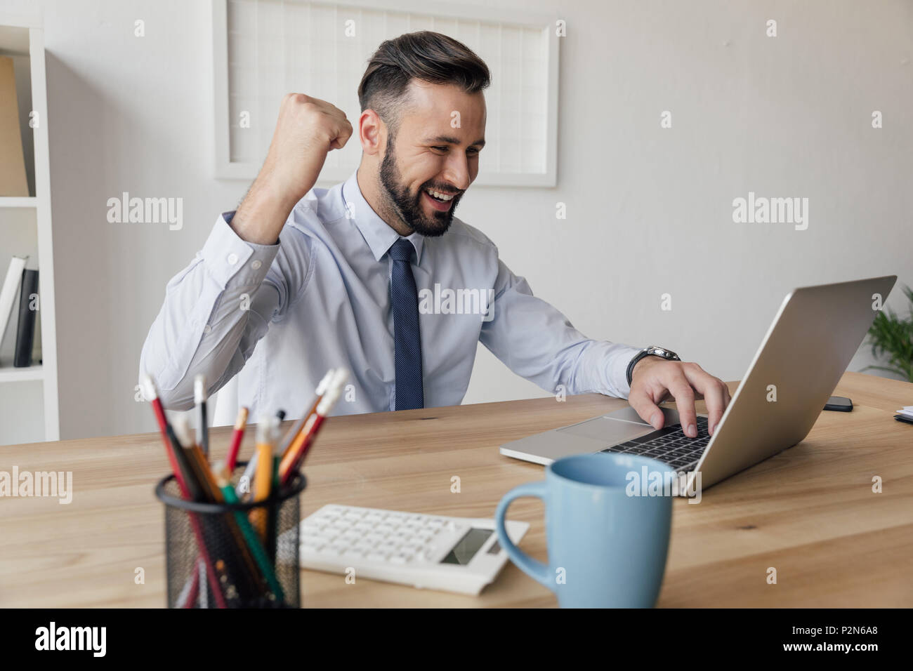 portrait of happy businessman typing on laptop in modern office Stock ...