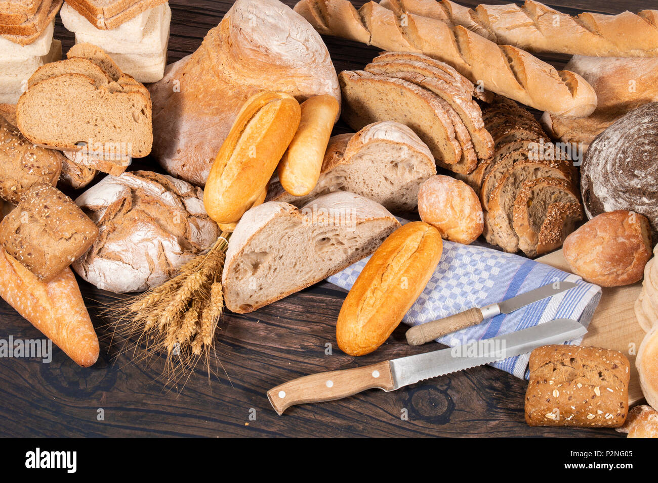 Fresh Assortment of several baked bread varieties on a wooden table ...