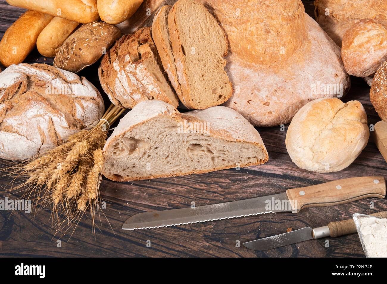 Fresh Assortment of several baked bread varieties on a wooden table ...
