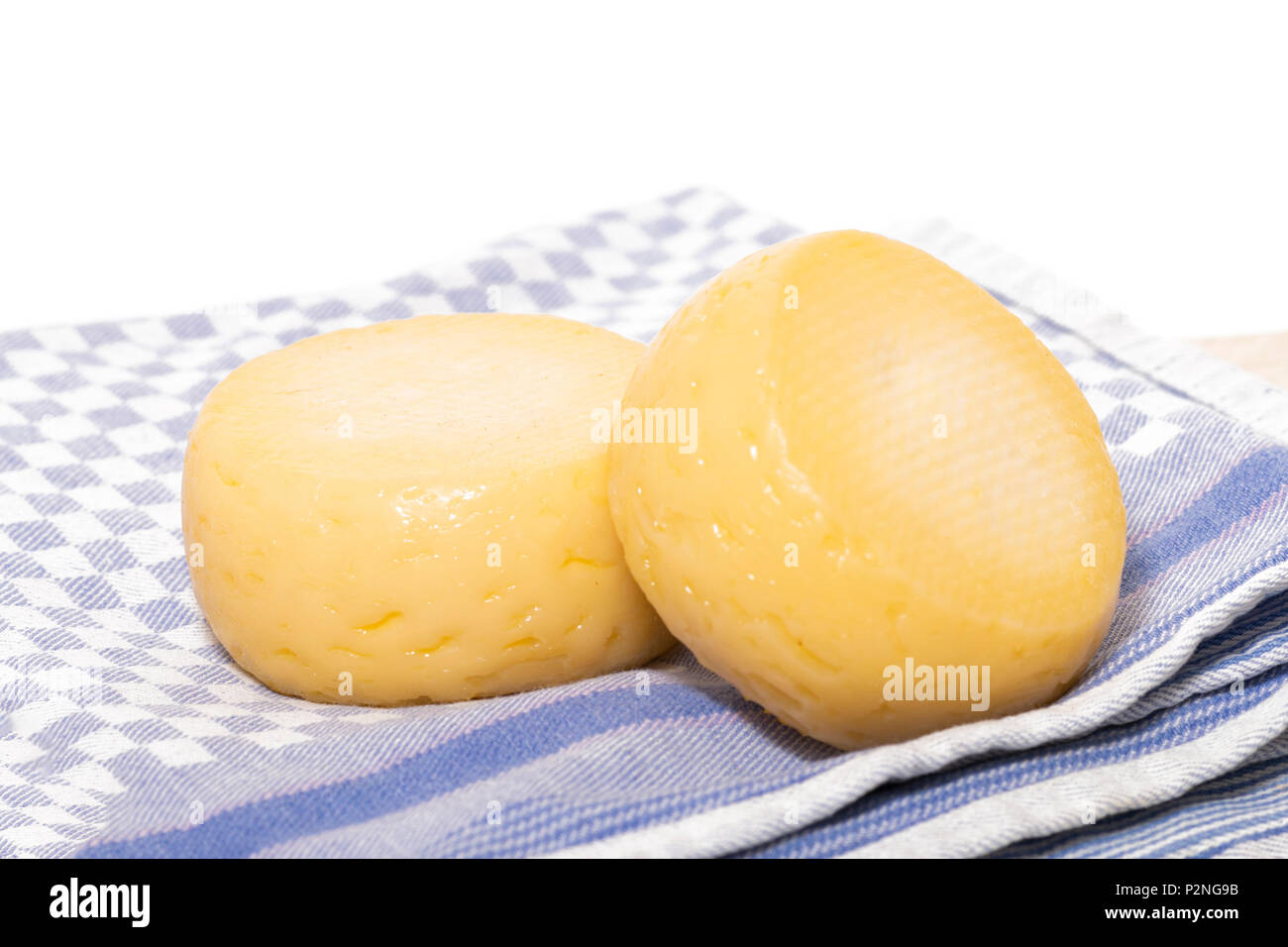 Yellow goat cheese isolated on a white background Stock Photo - Alamy