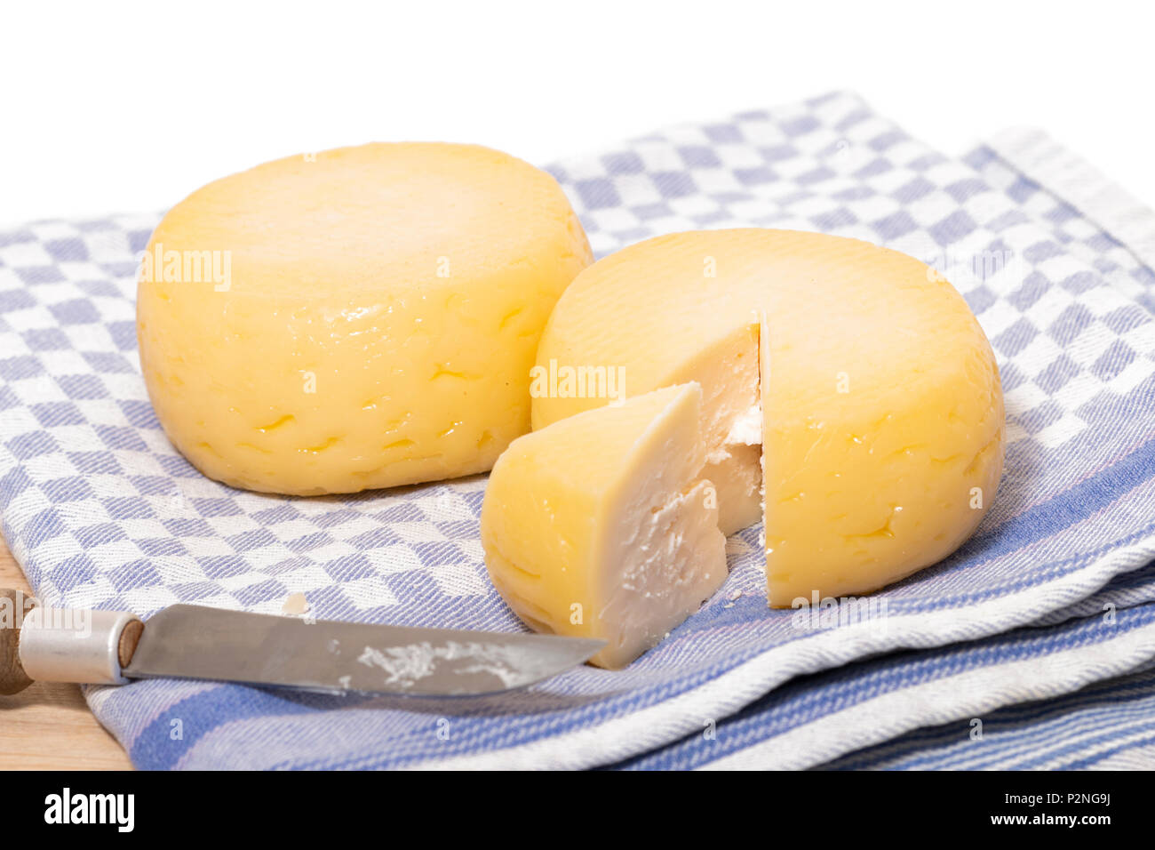 Yellow goat cheese isolated on a white background Stock Photo - Alamy